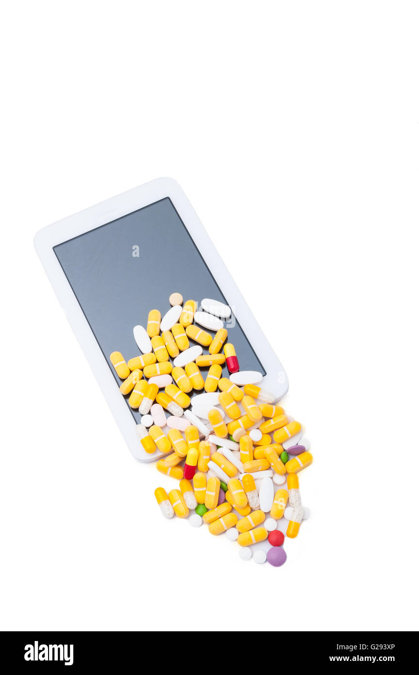 Bunch of colored pills and wireless tablet isolated on white background ...