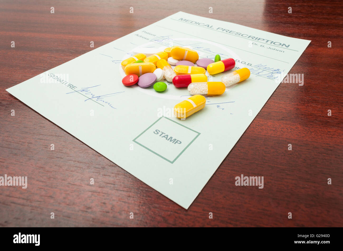 Doctor prescription for drugs filled out and signed full of pills on it ...