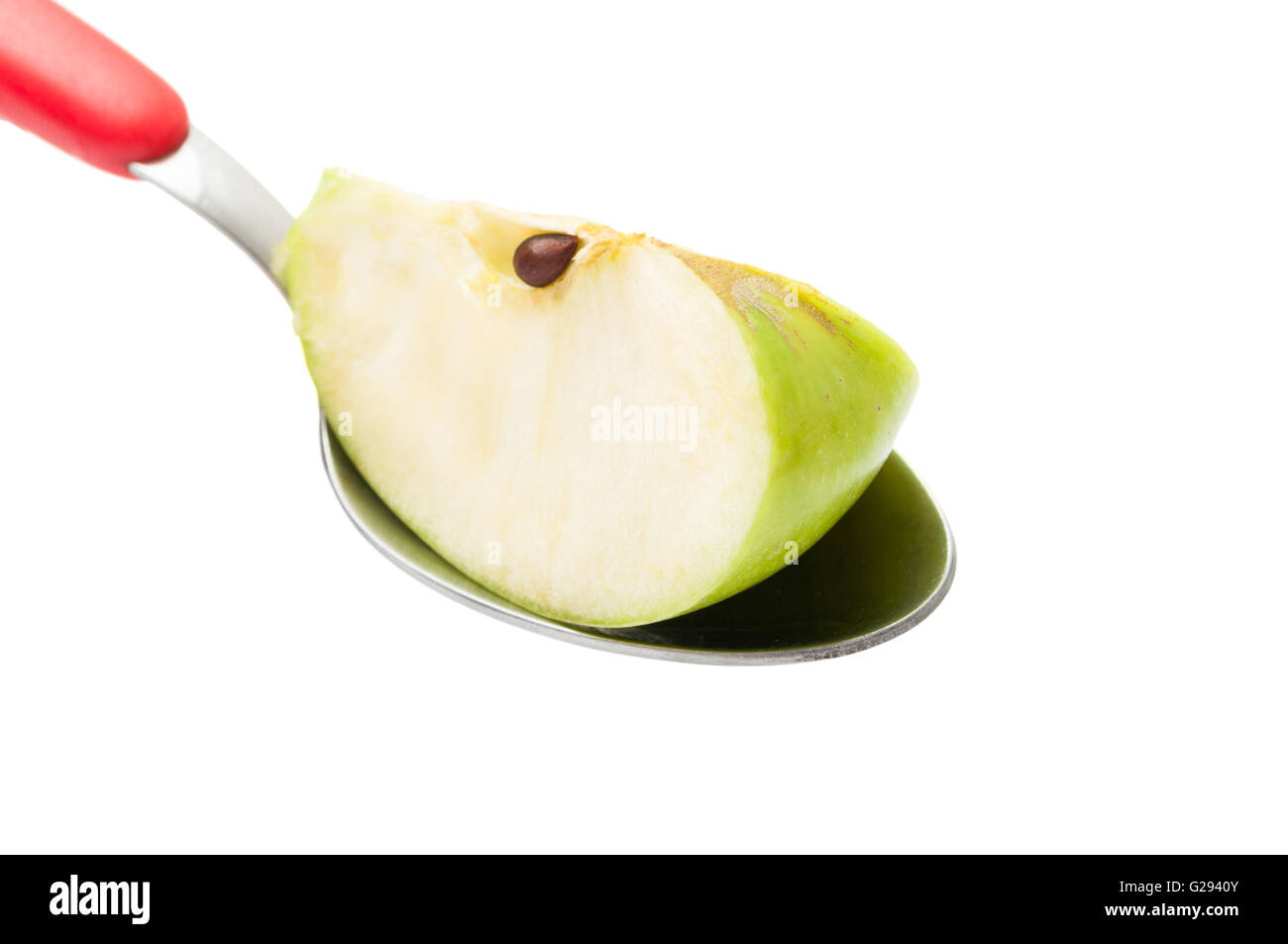 Green apple slice on a spoon isolated on white background Stock Photo ...