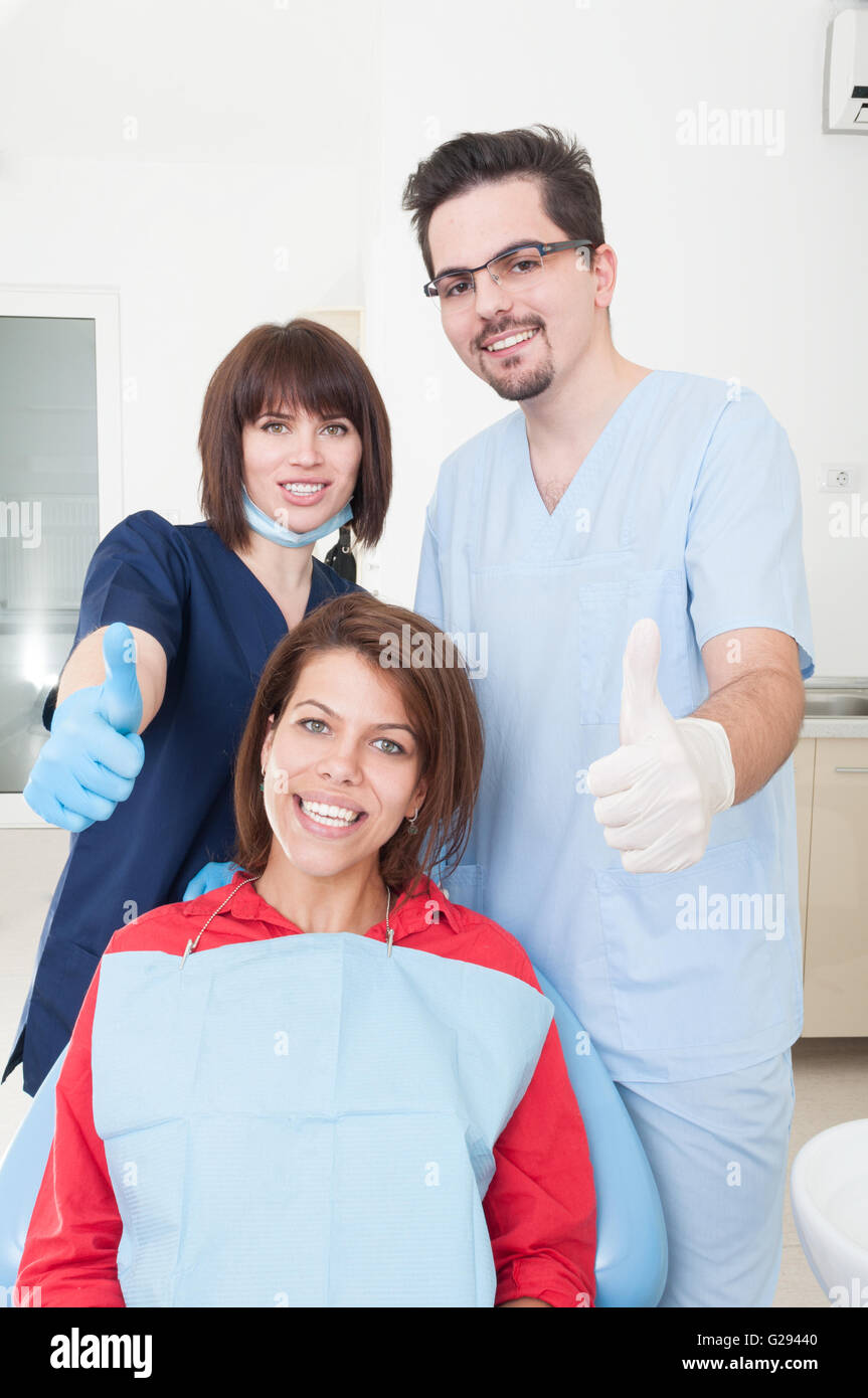 Friendly dentist team and patient with thumbs-up Stock Photo - Alamy