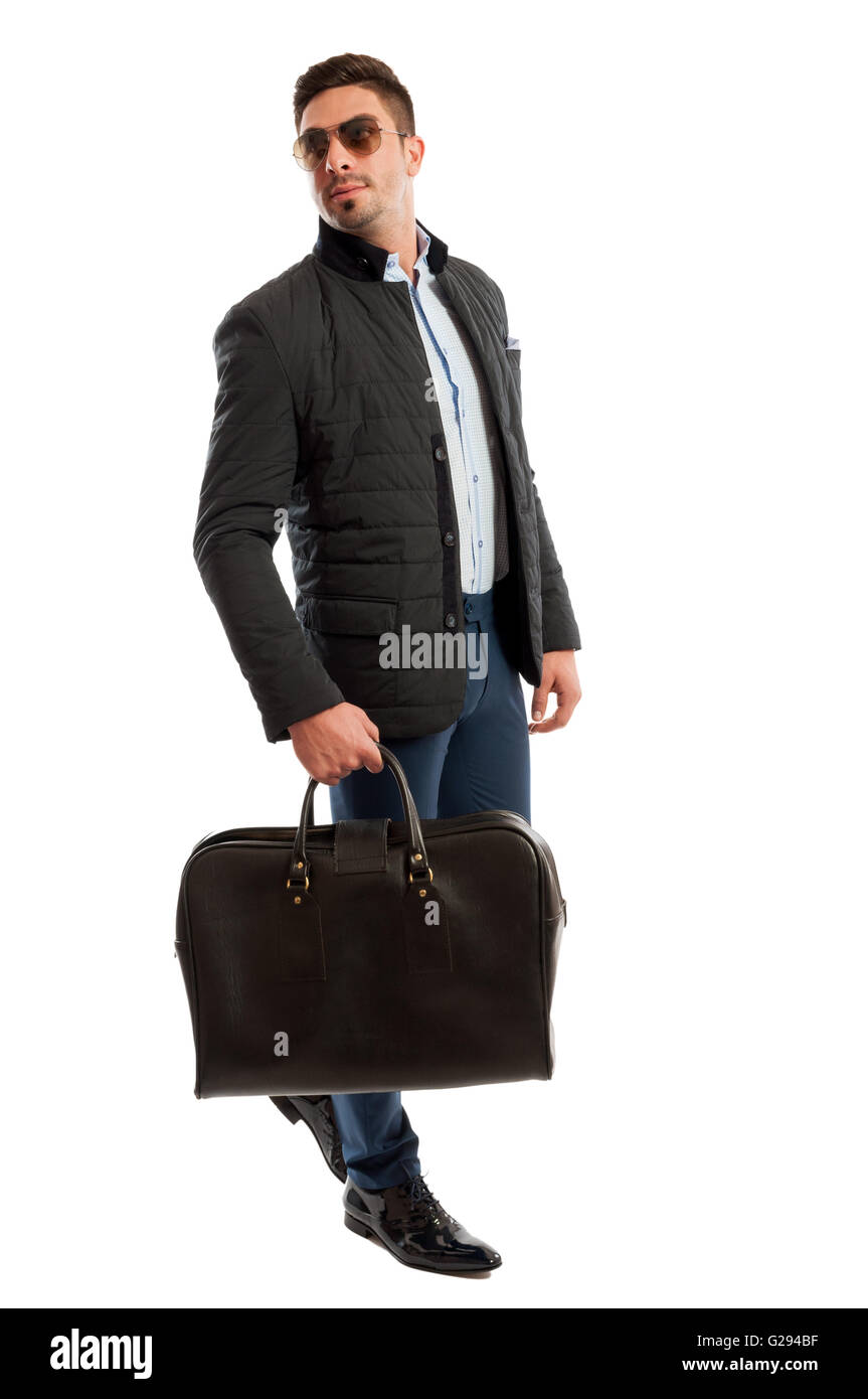 Male model posing as a business man ready for travelling holding a ...