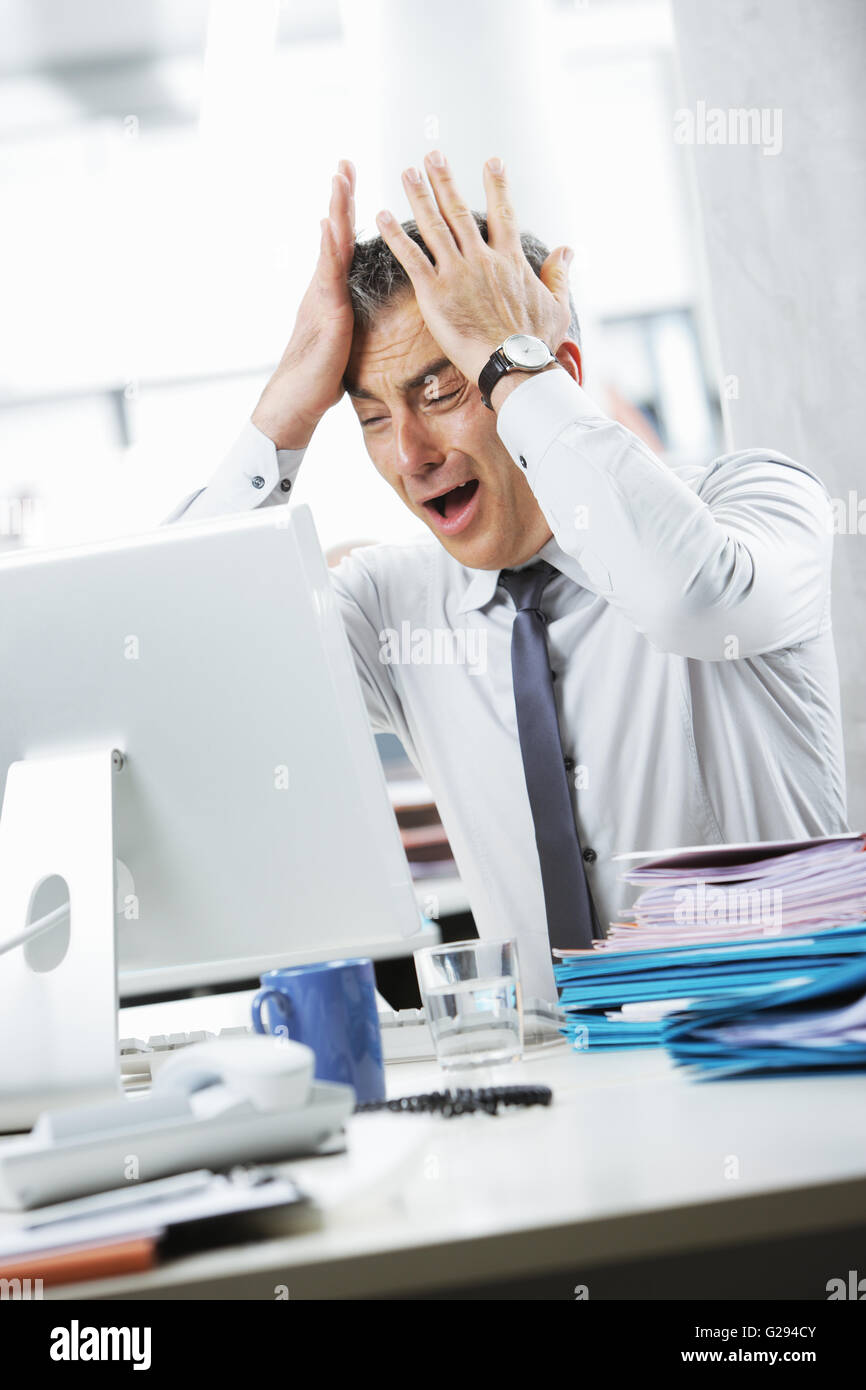 Businessman under stress, fatigue and headache, he kept his hands ...