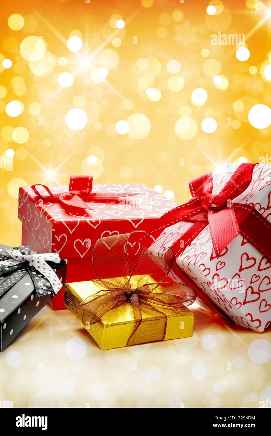 Group decorative gift boxes with ribbon. Front view. Golden bokeh ...