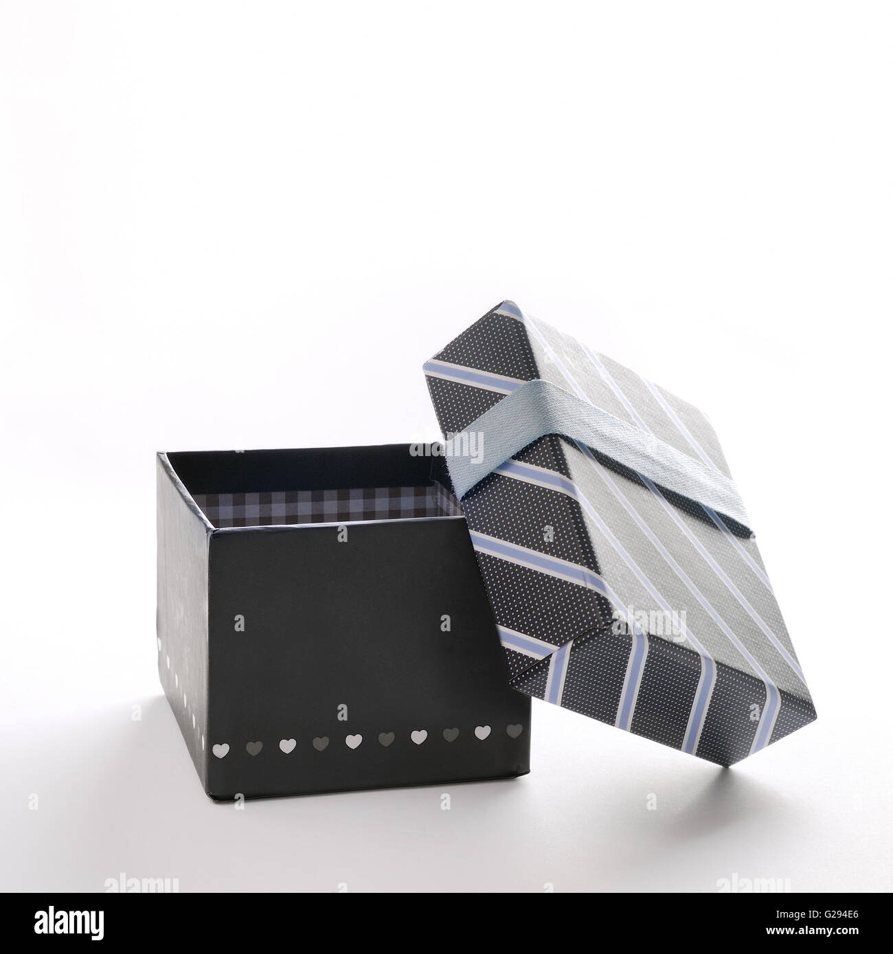 Decorative open black gift box with with ribbon and blue diagonal lines ...