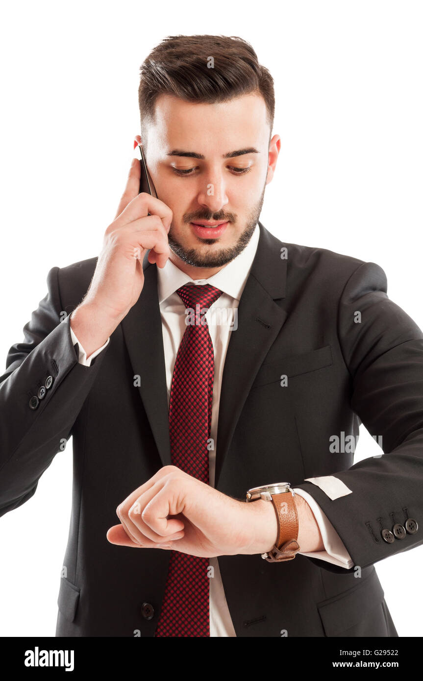 Business man talking on the phone while checking his watch on white ...
