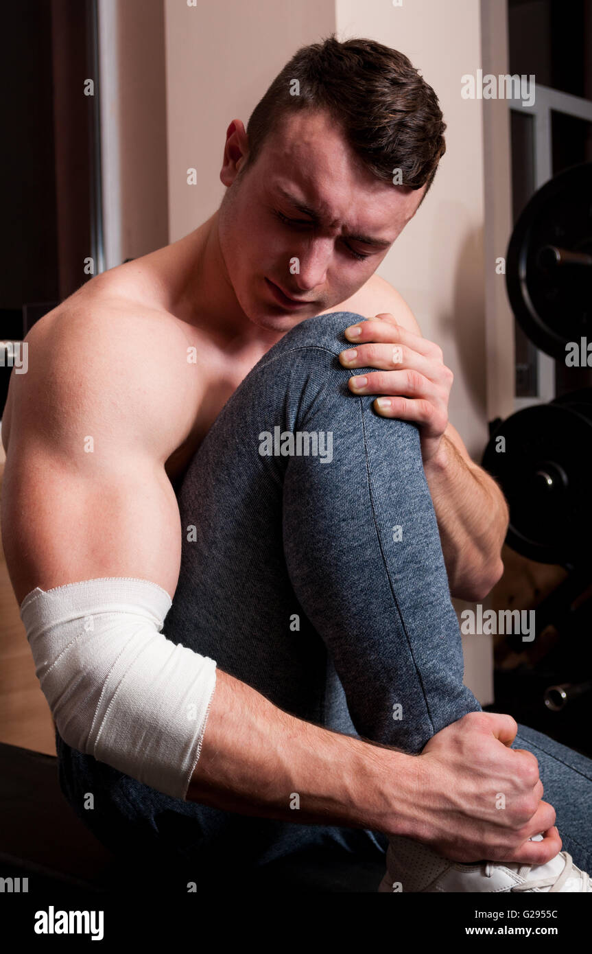 Body builder suffering after a gym injury Stock Photo - Alamy