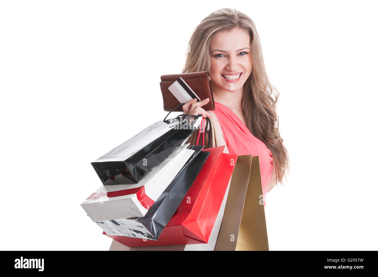 Portrait of a young and happy shopping lady on white studio background ...