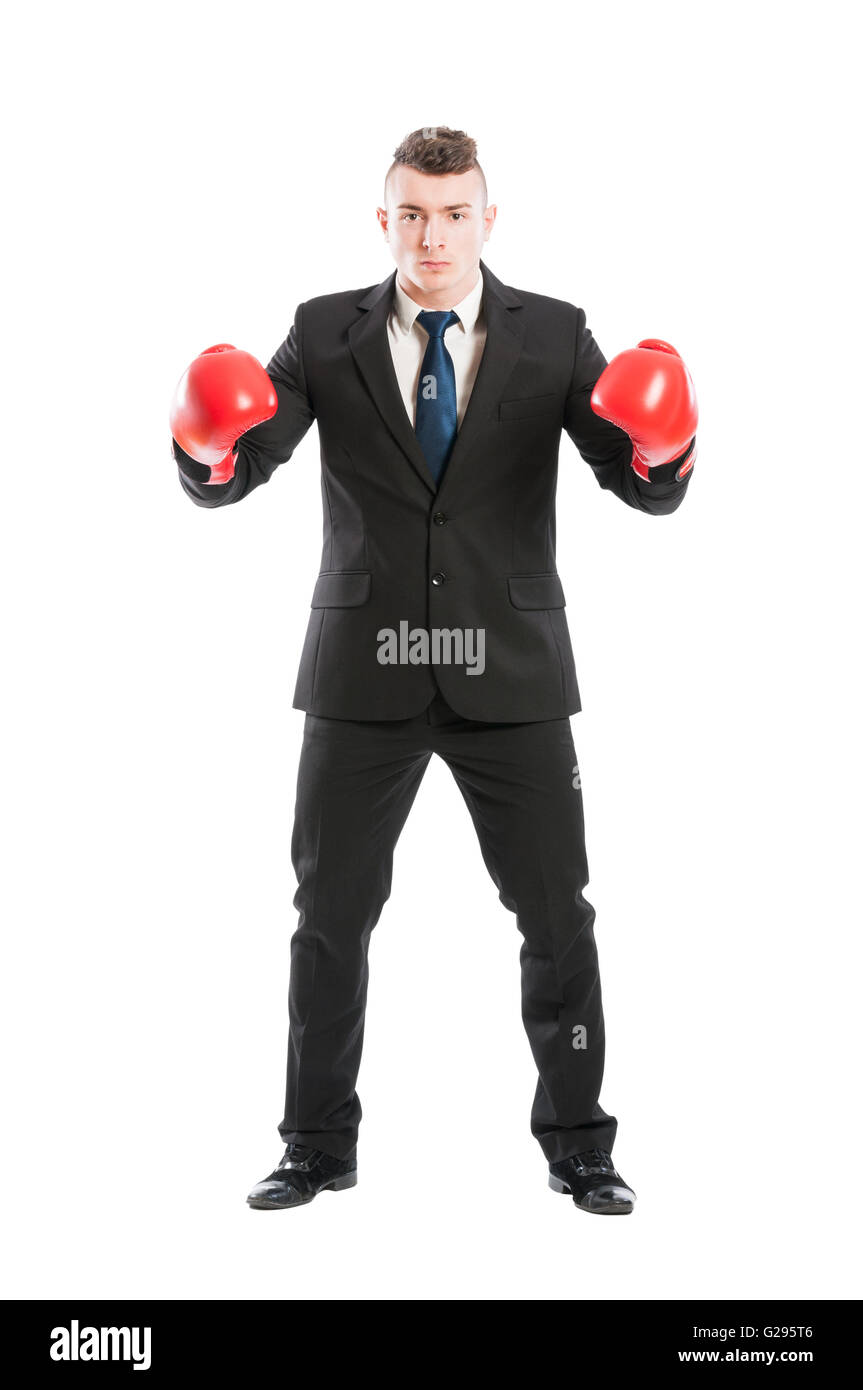 Business man ready to fight wearing suit, tie and red boxing gloves ...