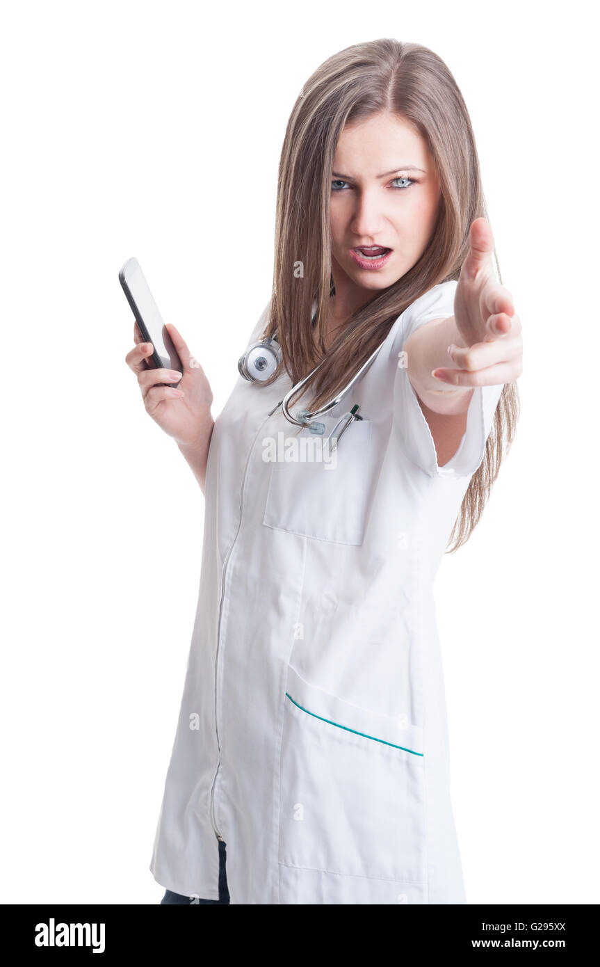Female doctor making shoot or gun gesture and holding a smartphone ...