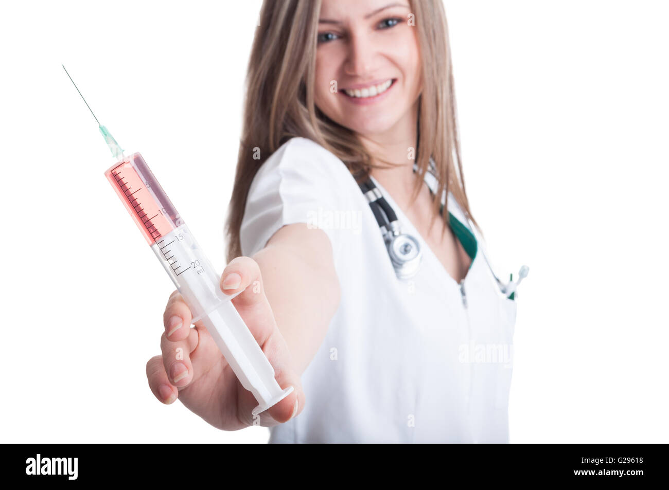 Woman doctor showing a syringe to the camera with focus on the needle ...