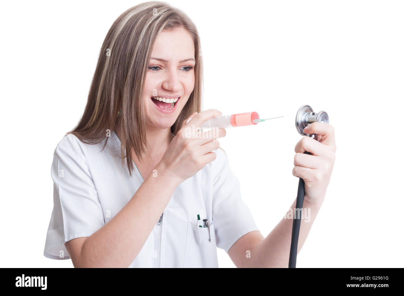 Happy female medic holding syringe and stethoscope on white background ...