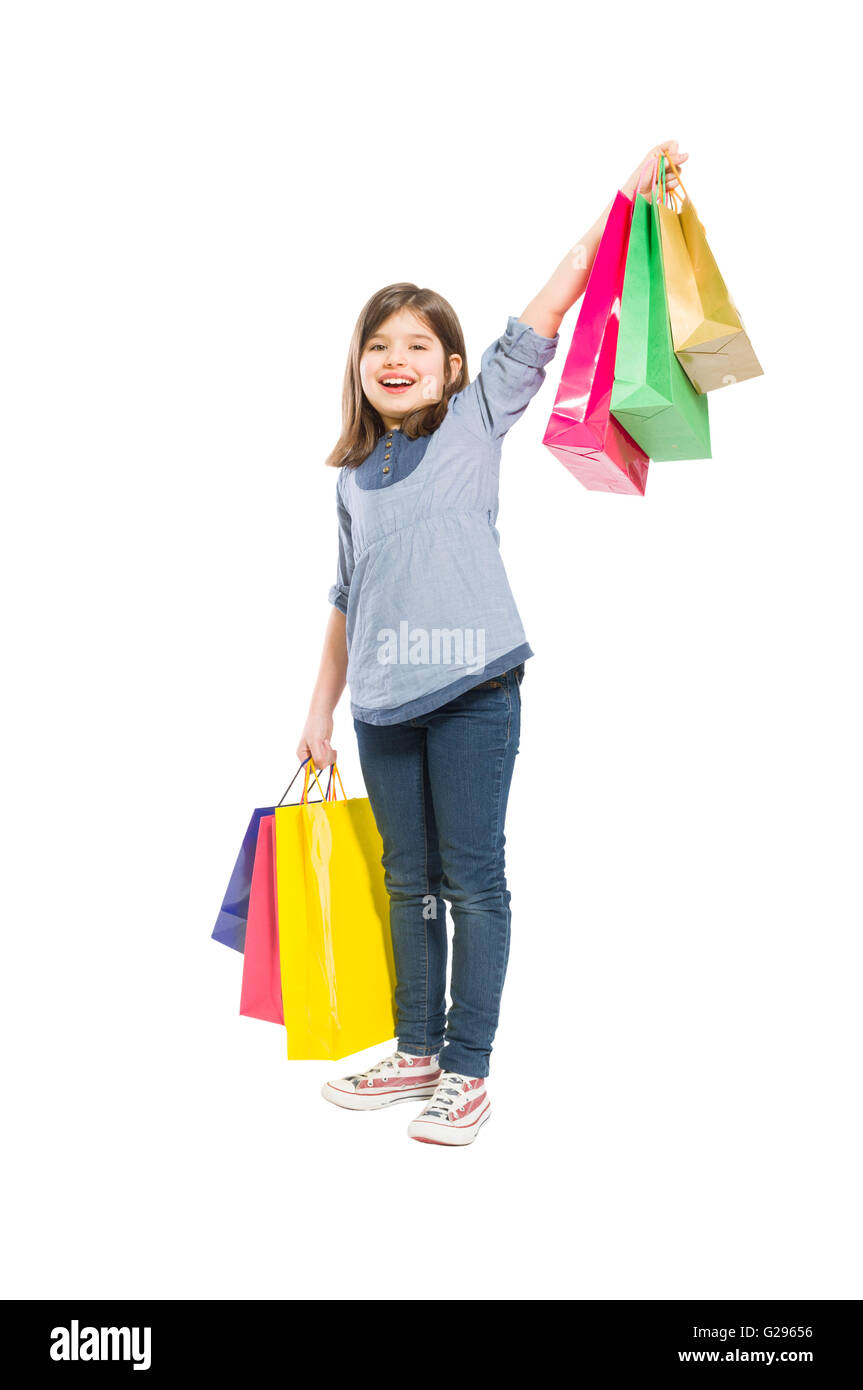 Young and cheerful shopping girl with shopping bags on white background ...