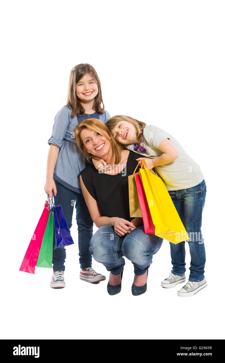 Happy shopping family with mother and two daughters on white background ...