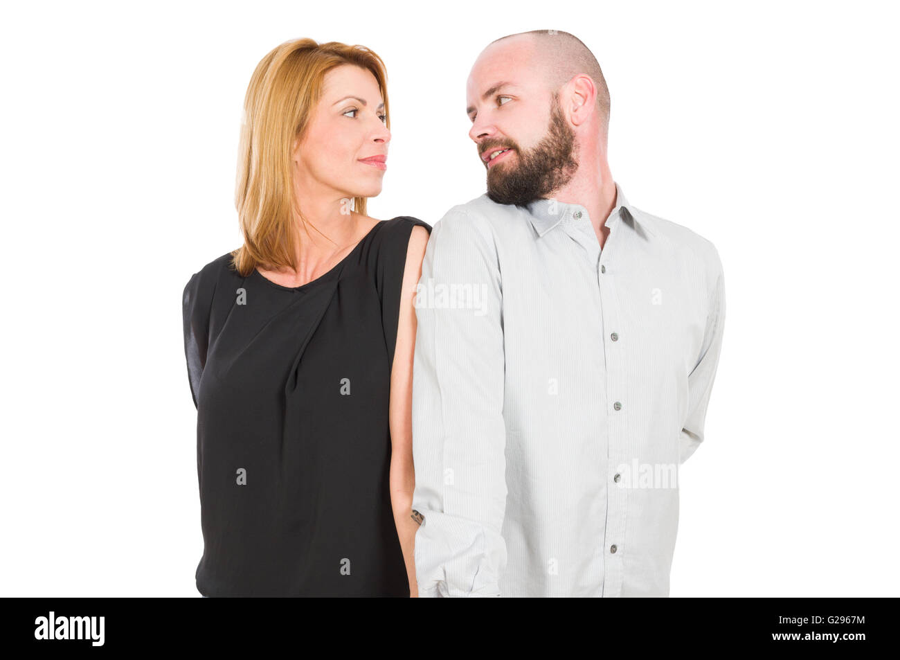 Beautiful young couple posing on white studio background Stock Photo ...
