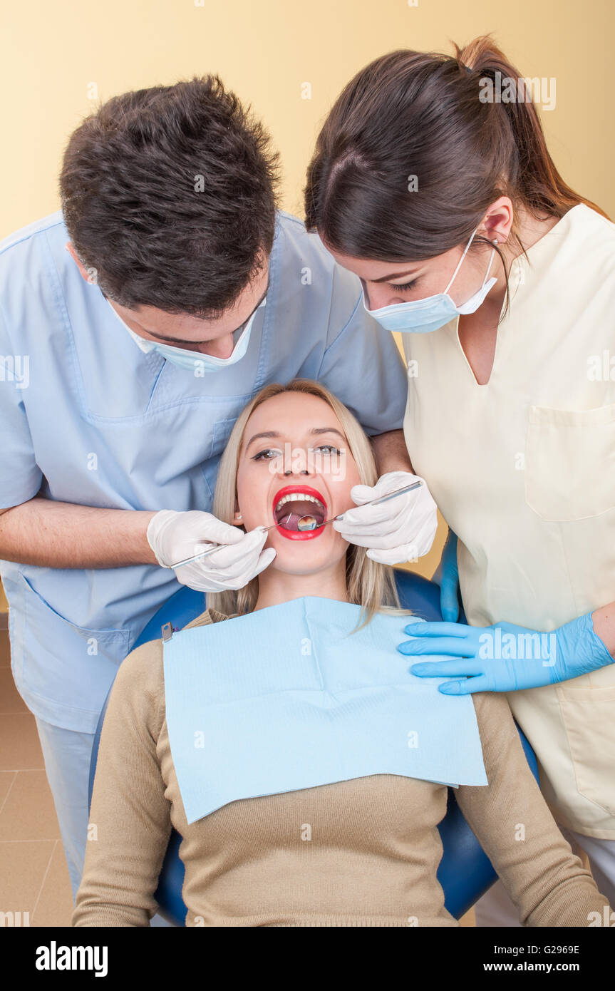 Dentist team working on beautiful mouth with perfect teeth or denture ...