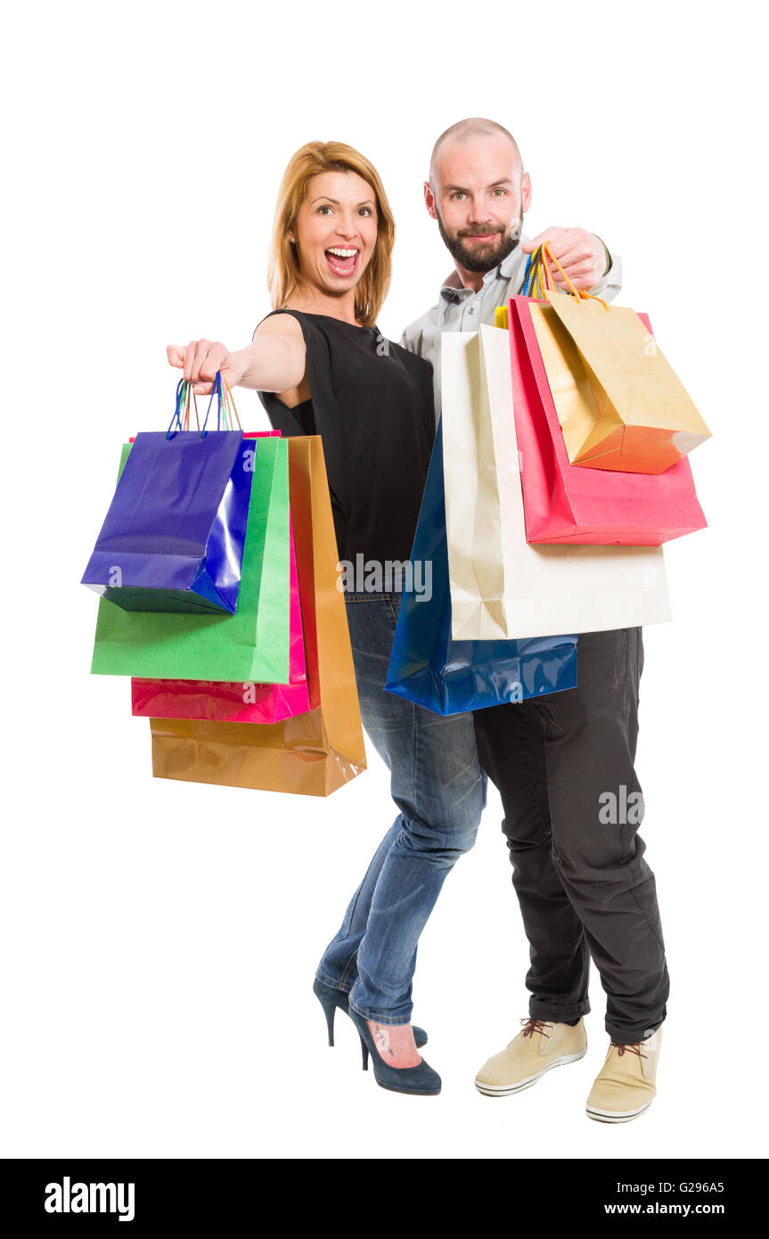 Excited and enthusiastic young shopping couple standing on white ...