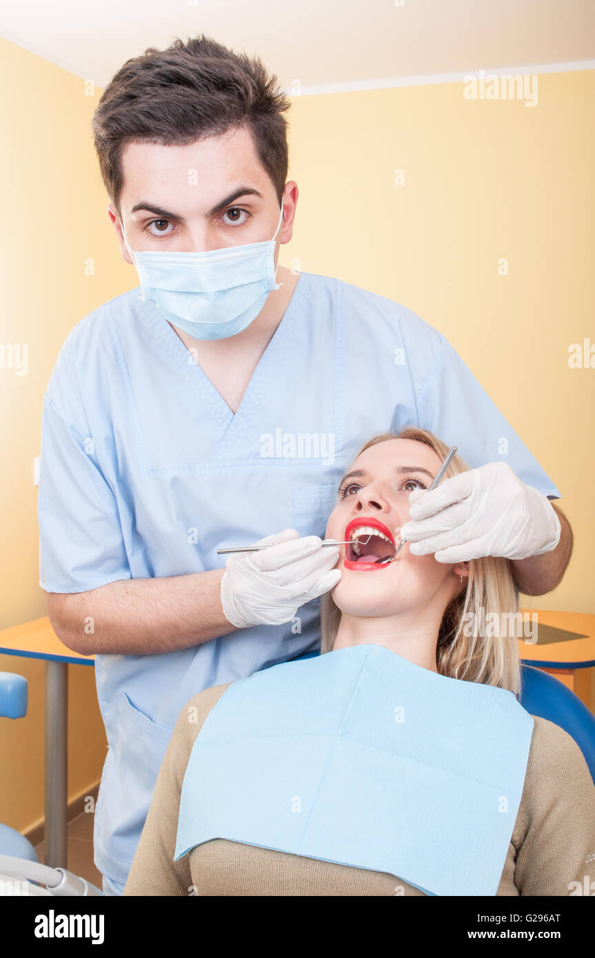 Dentist examine male patient mouth hi-res stock photography and images ...