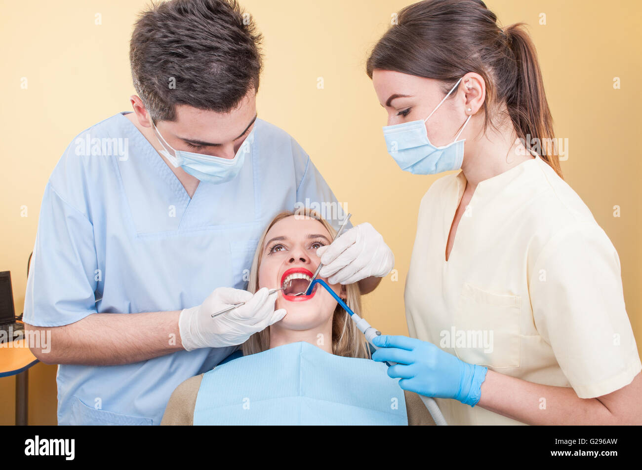 Dental team at work on a dentist office examining beautiful teeth and ...