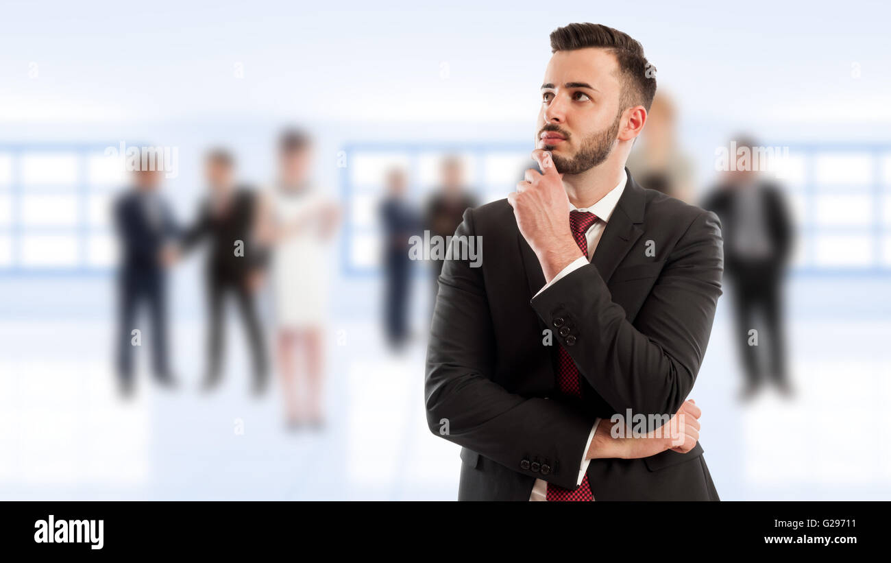 Smart and young business man thinking on business people background ...