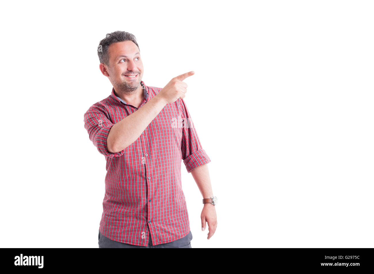 Man pointing and looking up while smiling isolated on white background ...