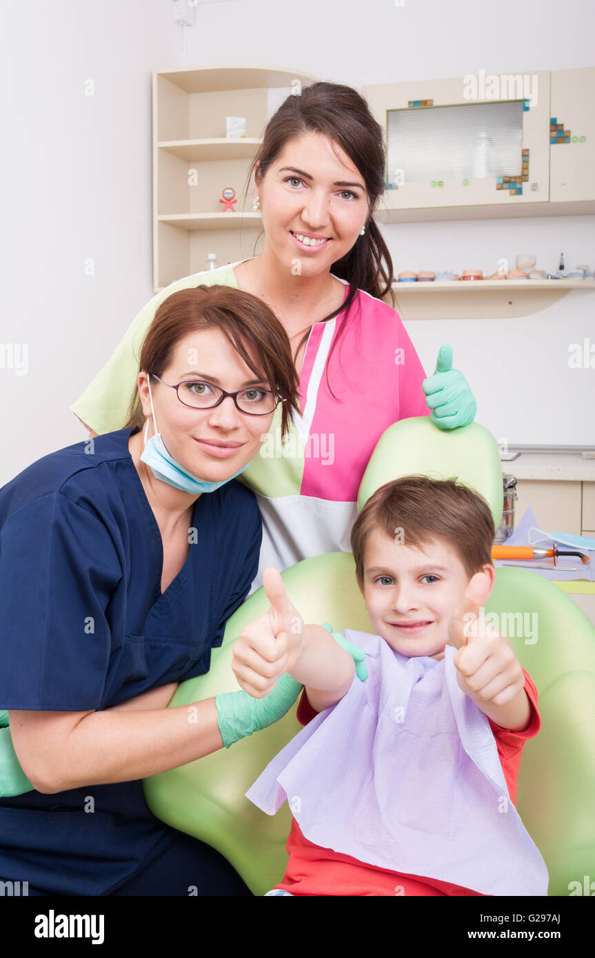 Child patient and dental team showing like or thumbsup in dentist ...