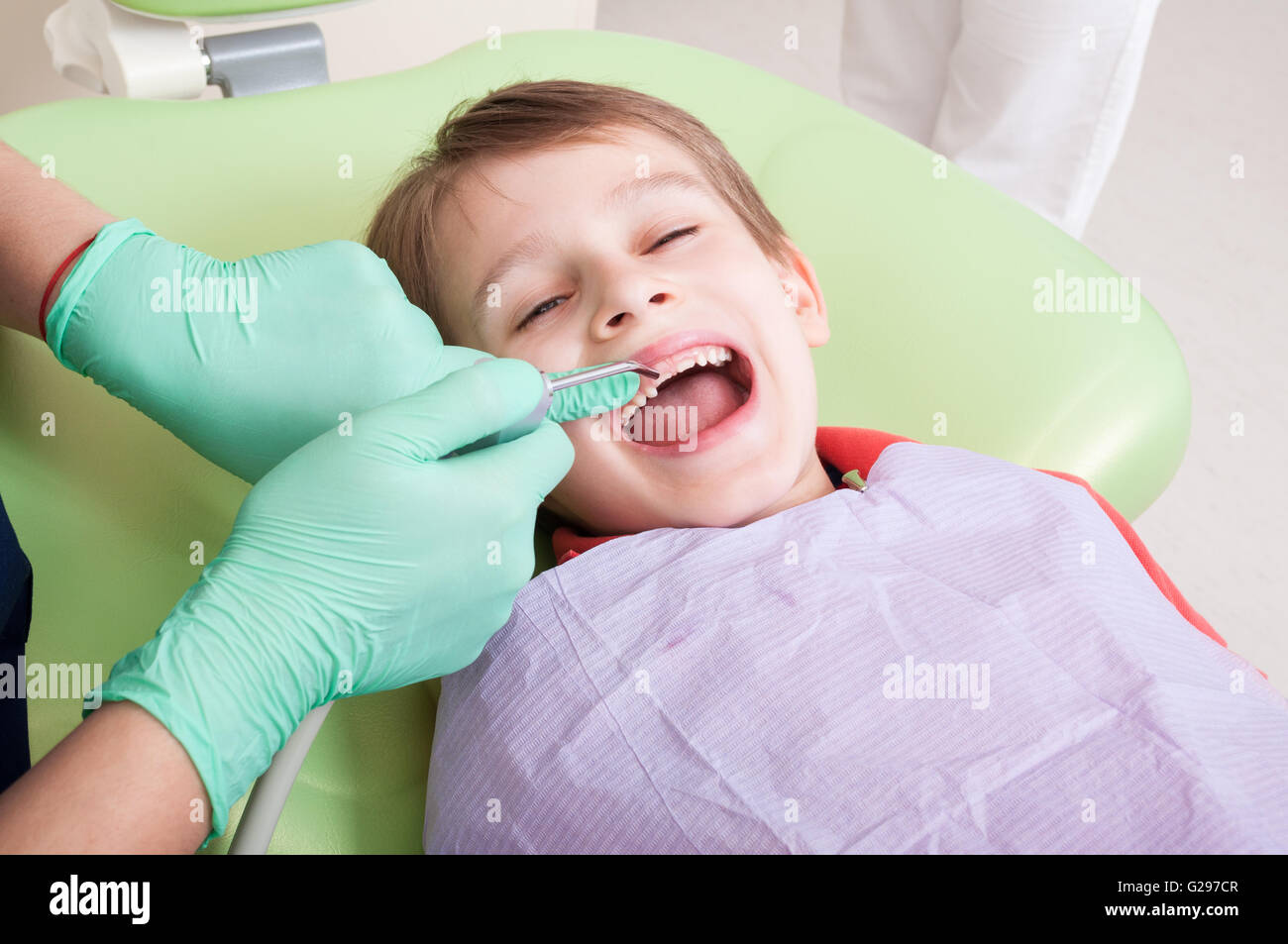 Relaxed kid in dentist chair ready for checkup procedure Stock Photo ...