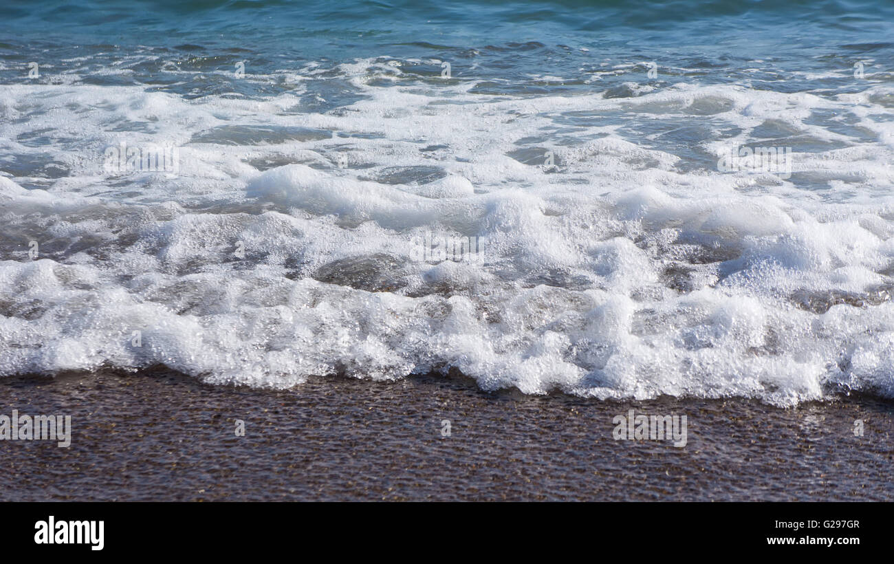 Sea shore with foamy blue water, seascape Stock Photo - Alamy