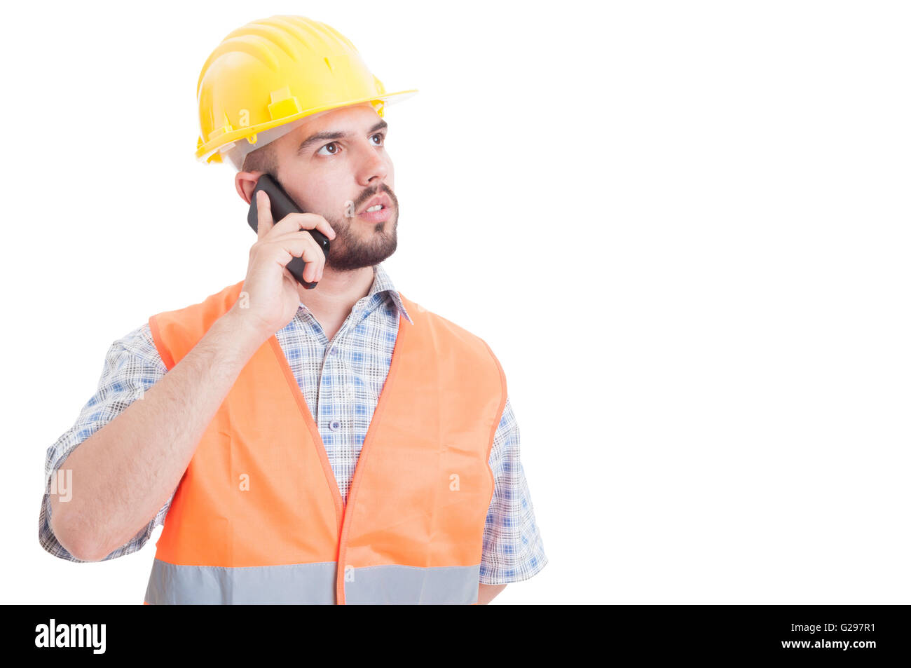 Smart, young and modern engineer talking on smartphone while looking up ...