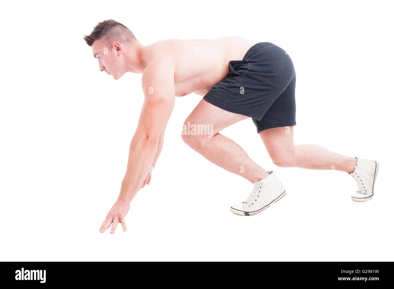 Side view of a man in running start position isolated on white Stock ...
