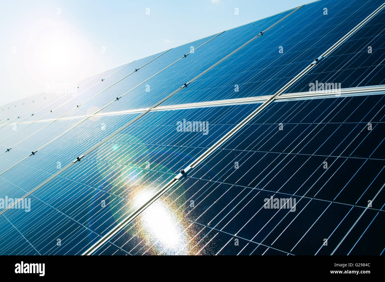 Sunray reflecting on solar power photovoltaic panel as green and ...