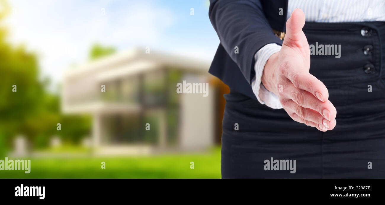 Handshake offer on outdoor house background as real estate concept ...