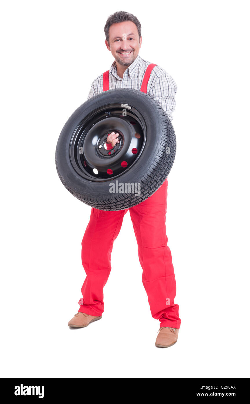 Strong mechanic lifting car wheel with tire isolated on white Stock ...