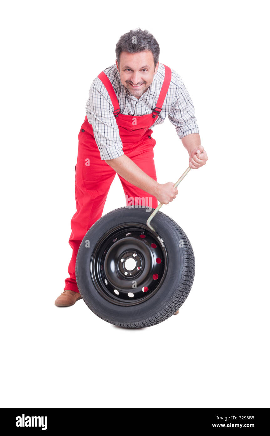 Smiling mechanic changing tire isolated on white background Stock Photo ...