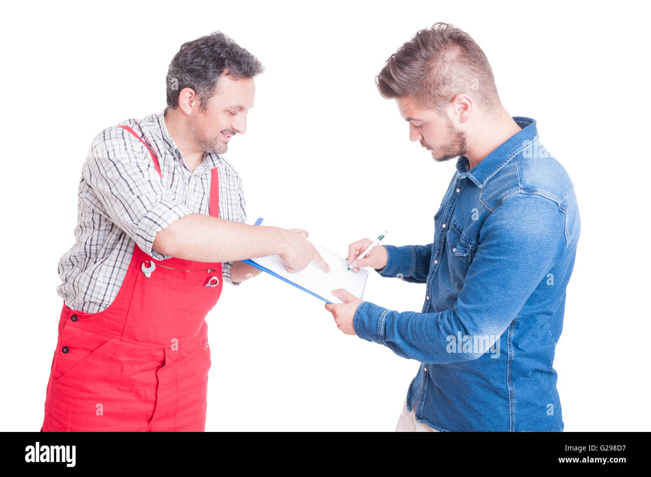 Car service client signing document on clipboard with mechanic pointing ...