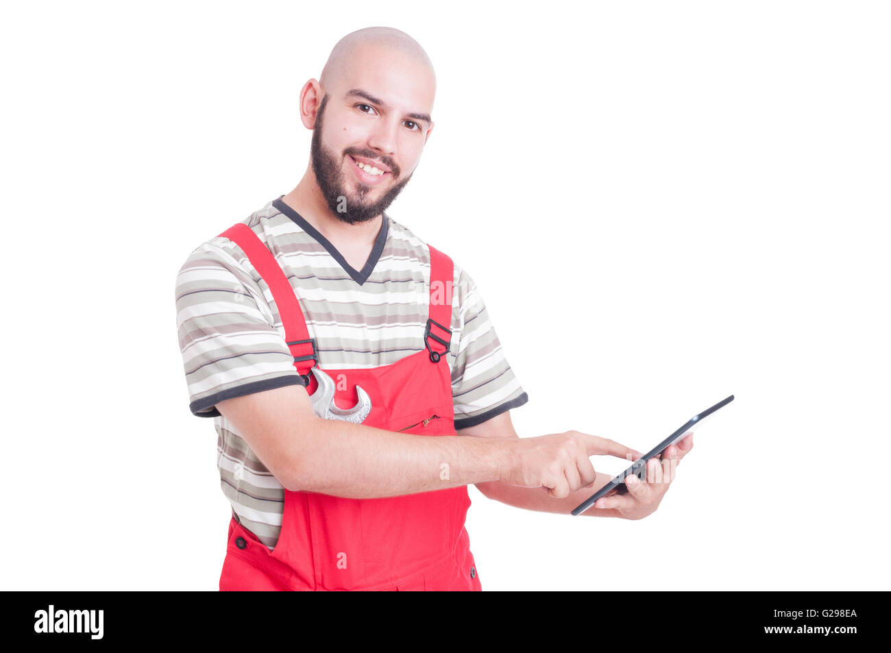 Happy friendly and young mechanic using a wireless tablet isolated on ...