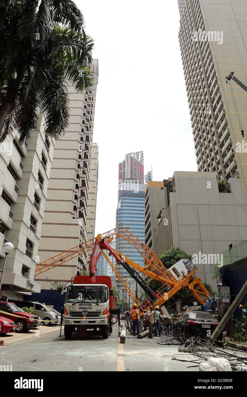 Makati City, Philippines. 26th May, 2016. Workers clear the debris ...