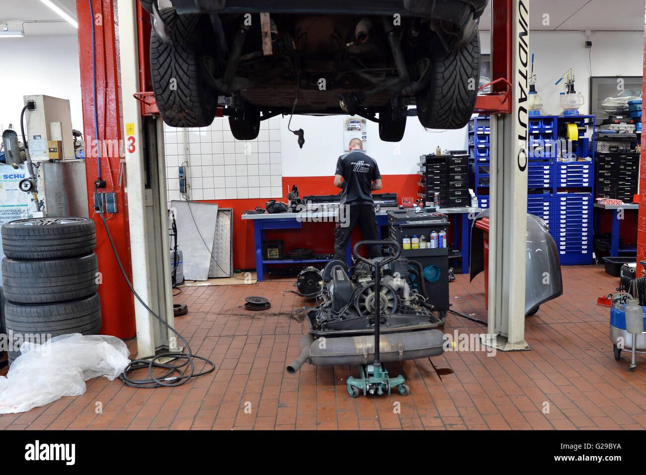 Berlin, Germany. 23rd May, 2016. An car mechanic repairs a car in an ...