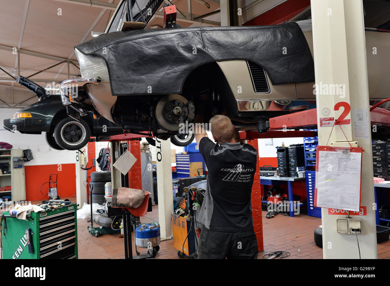 Berlin, Germany. 23rd May, 2016. An car mechanic repairs a car in an ...