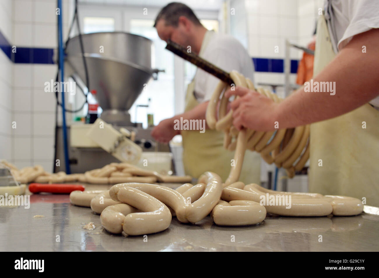 Berlin, Germany. 23rd May, 2016. Butchers make sausages in a butcher's ...