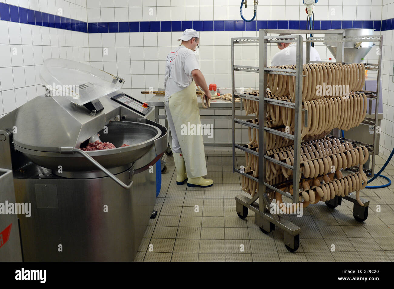 Berlin, Germany. 23rd May, 2016. Butchers make sausages in a butcher's ...