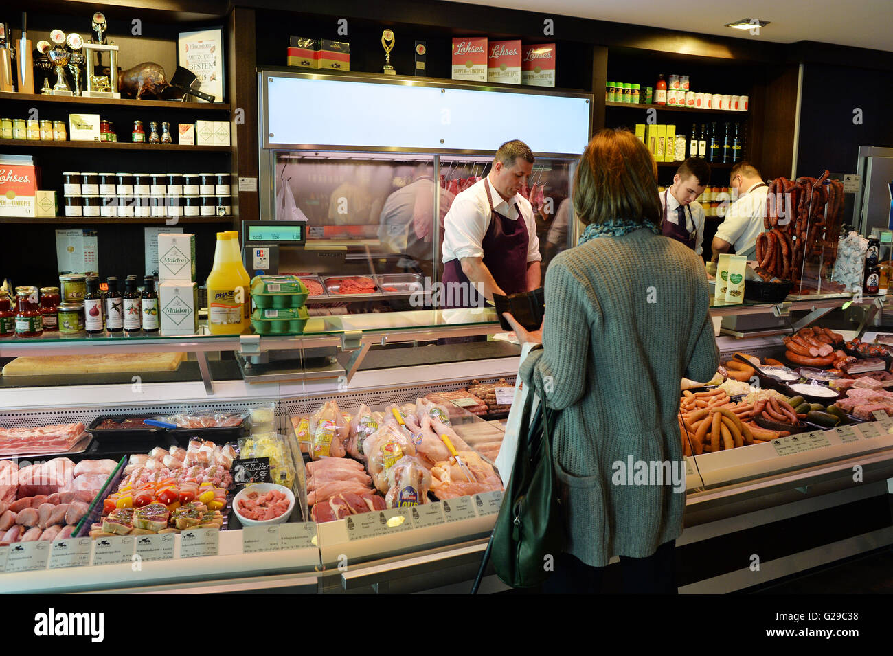Meat and sausage products can be seen at a shop counter in a butcher's ...
