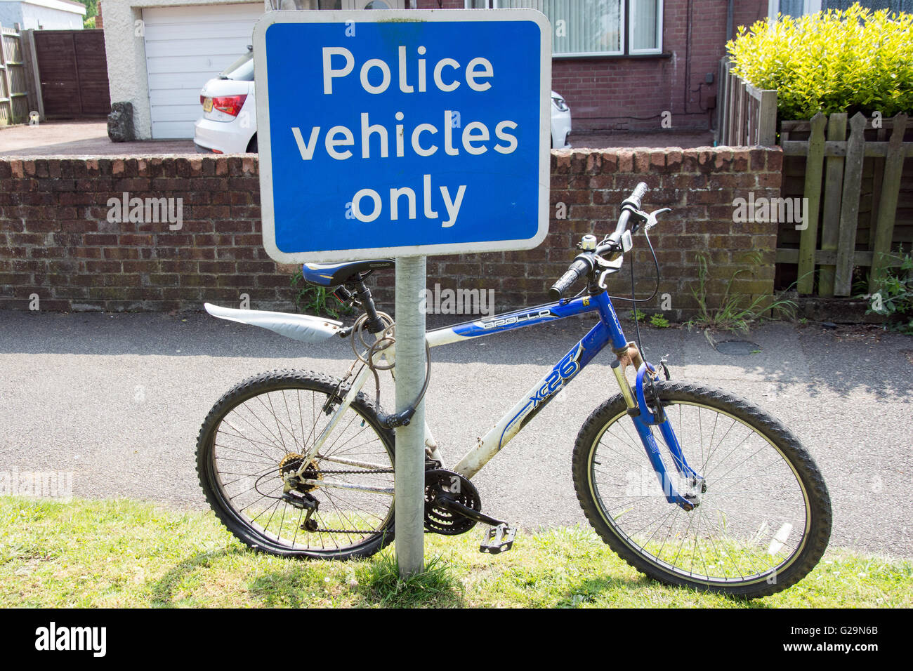 Old bicycle leaning against a sign for police vehicles only Stock Photo ...