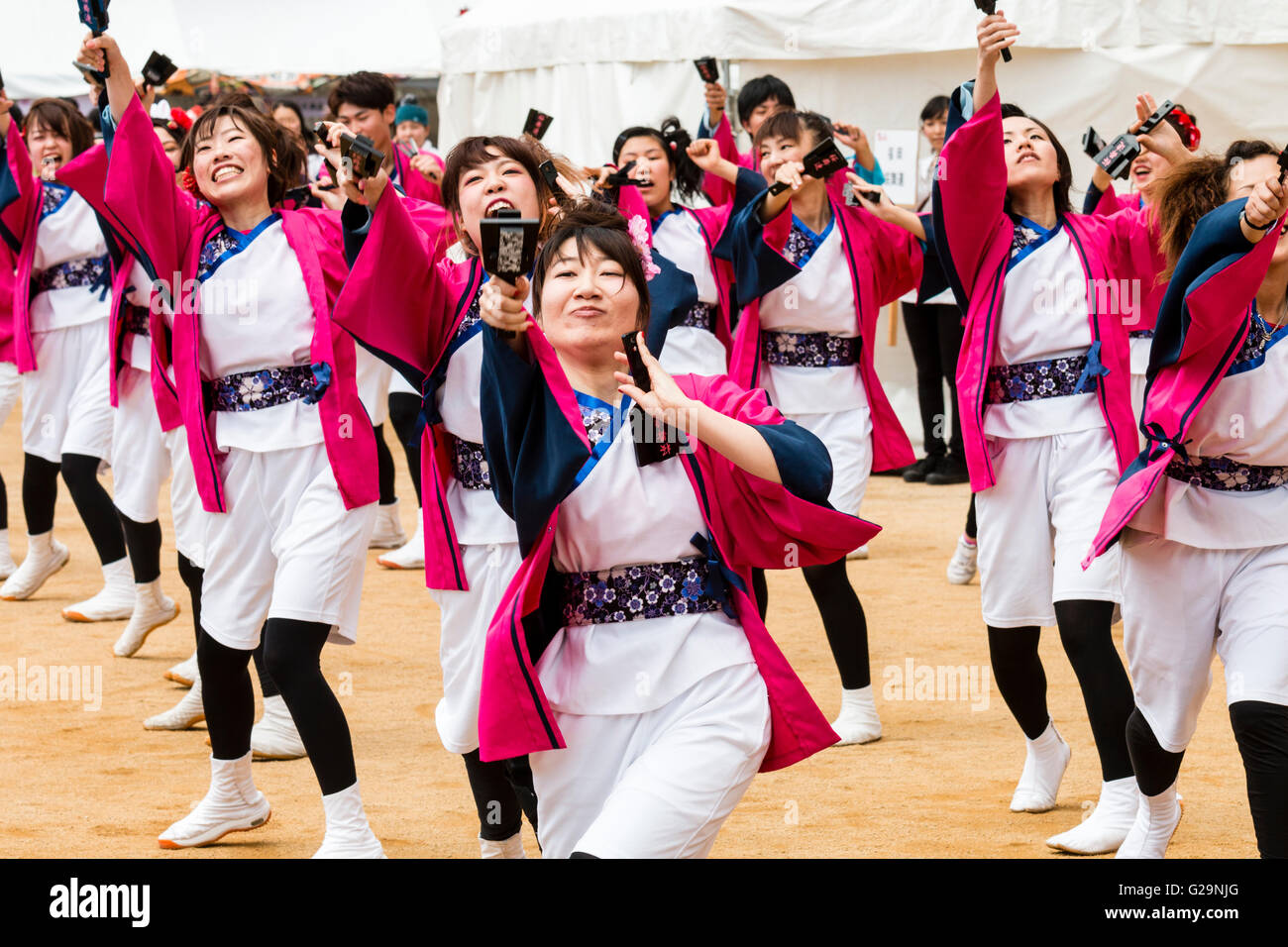 Japan, Kumamoto. Hinokuni Yosakoi dance festival. Women team in pink ...