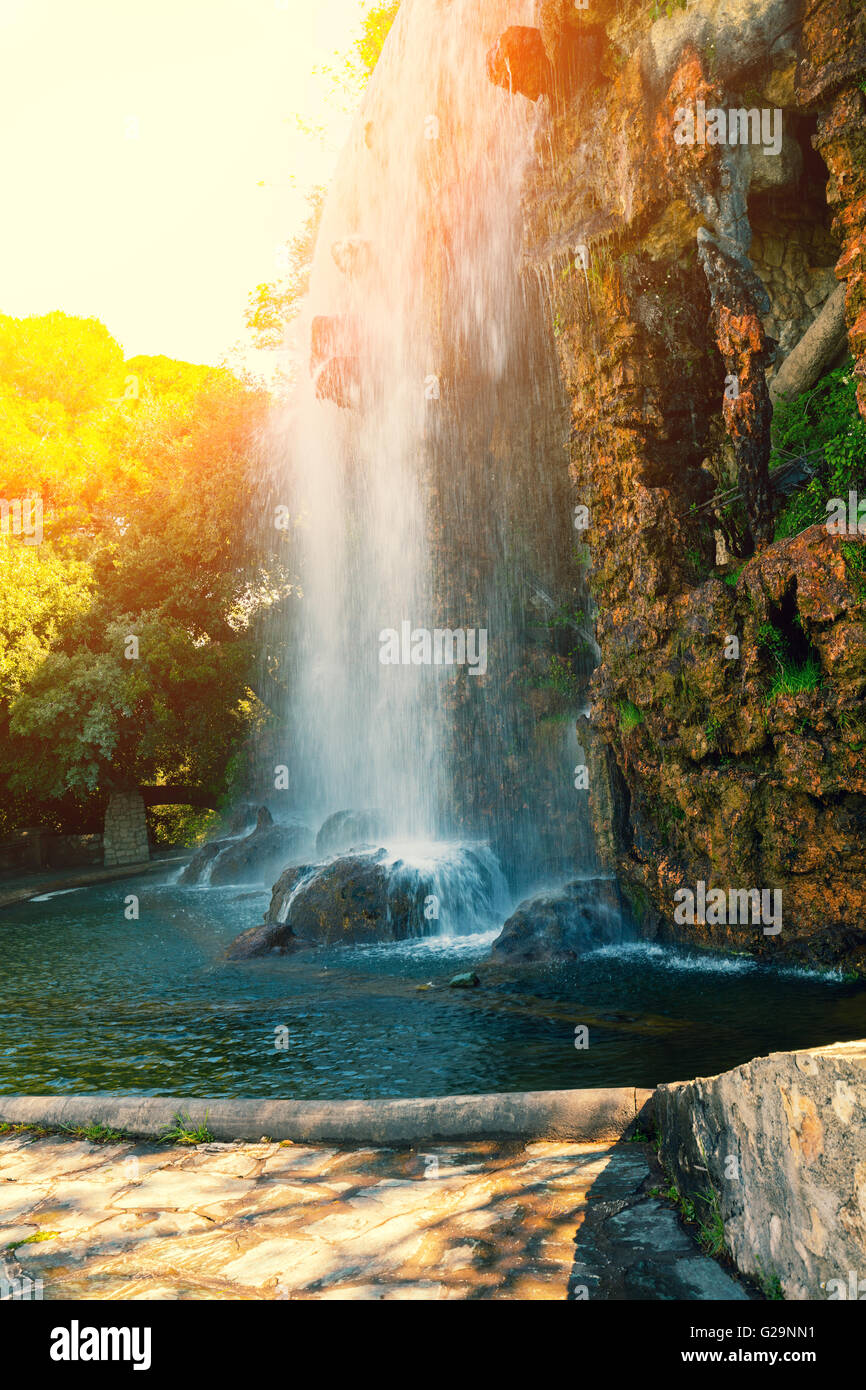 Waterfall in the park at sunrise Stock Photo - Alamy