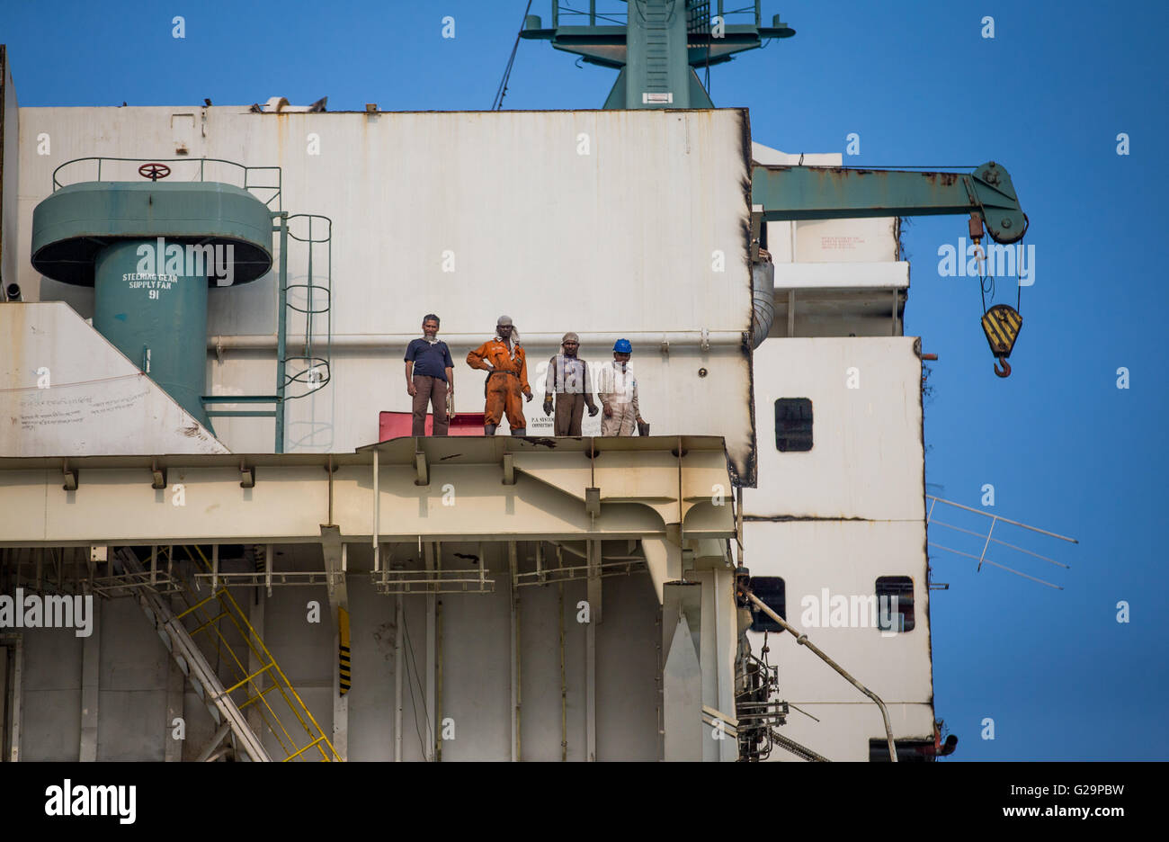 workers on a partially broken down ship in ship breaking yard in ...