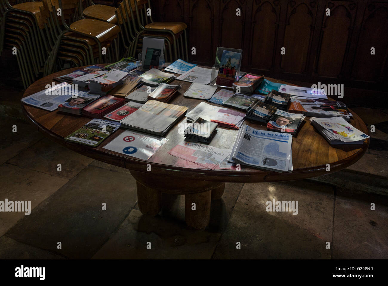Leaflets on a table in Church of Our Lady of the Nativity. Magny-en ...