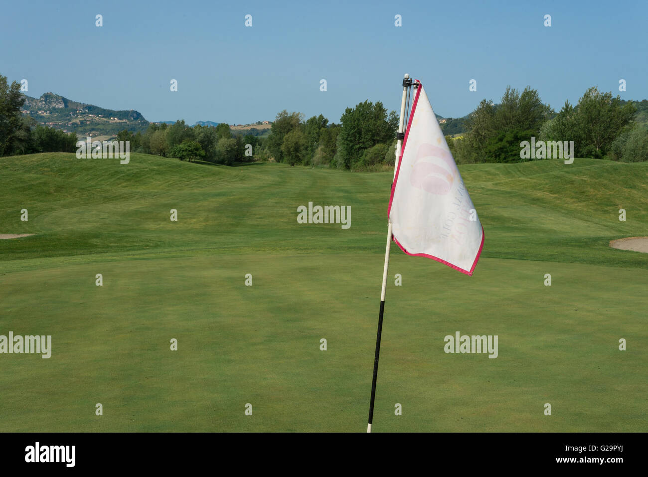 a view of a beautiful golf course and a flag Stock Photo - Alamy