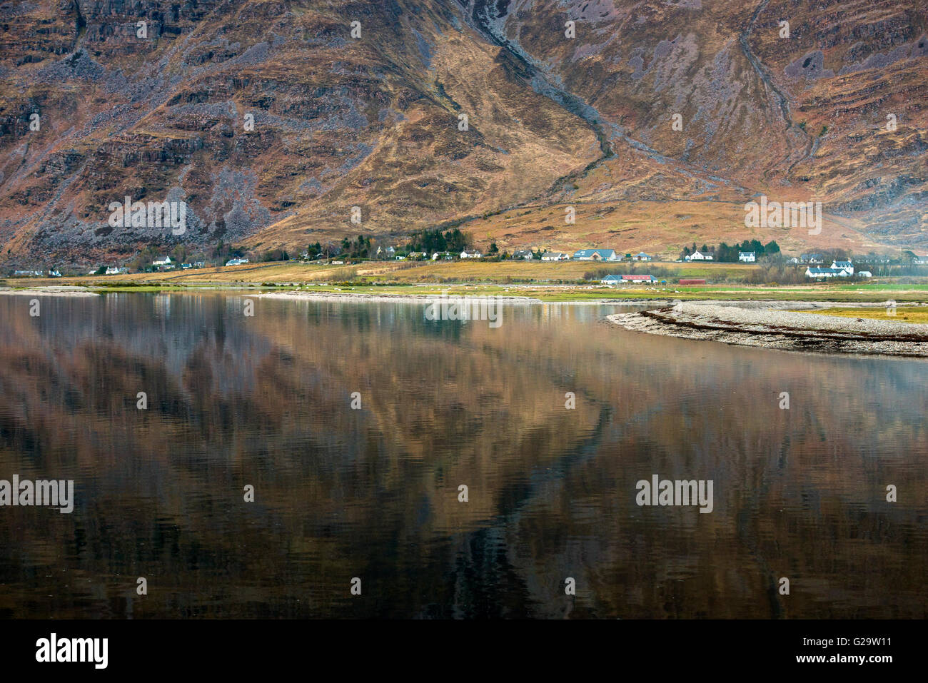 The Village of Torridon and mountains reflected in a very calm and ...