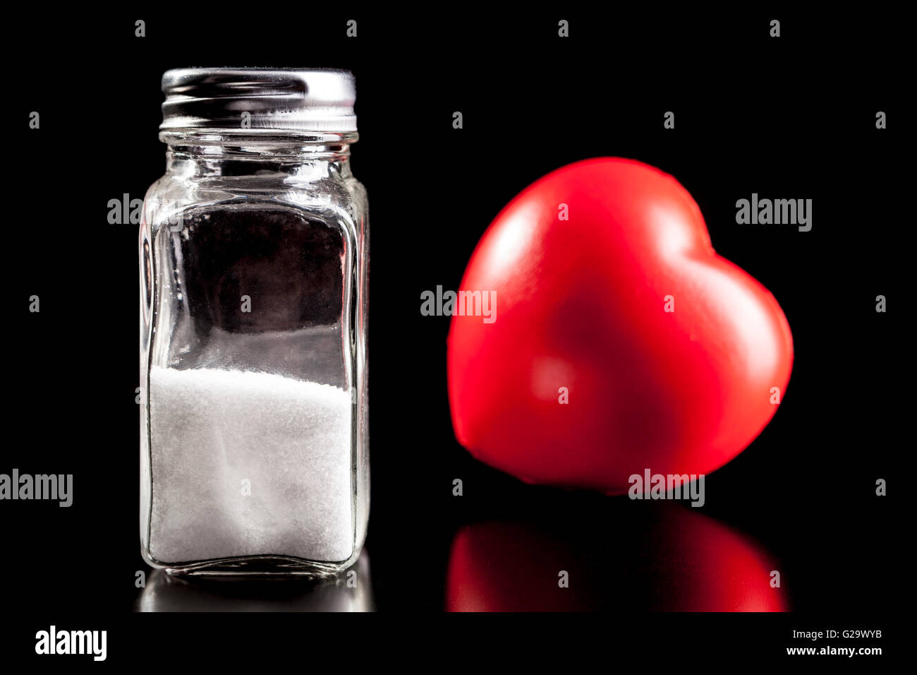 Heart and salt isolated on black background with reflection Stock Photo ...