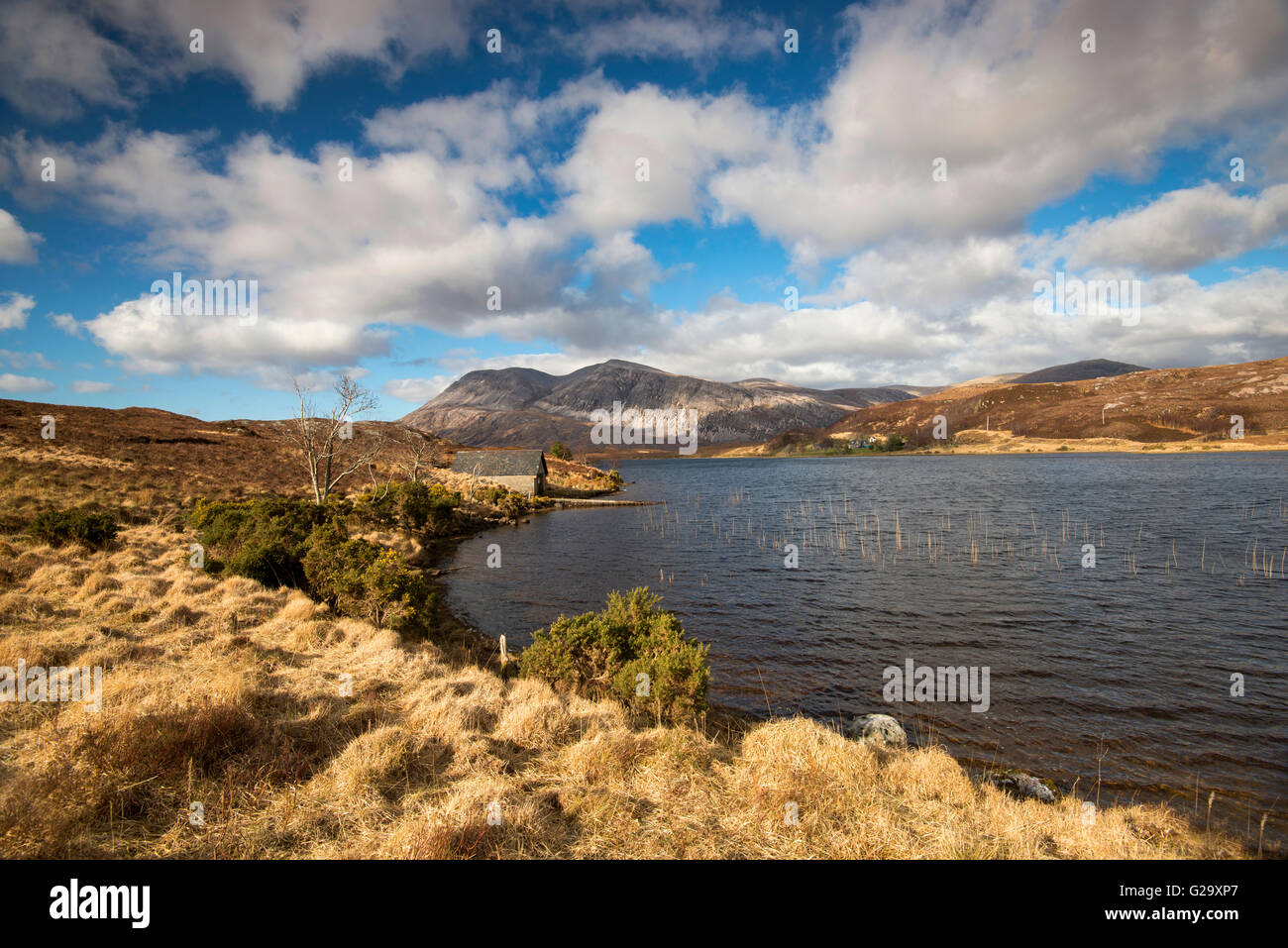 View of a boathouse on Loch Stack, with Ben Arkle in the background ...